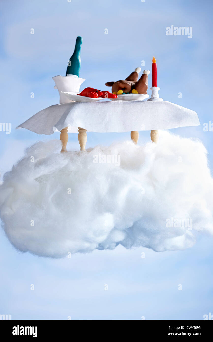 Covered table standing on a cloud made of cotton wool Stock Photo - Alamy