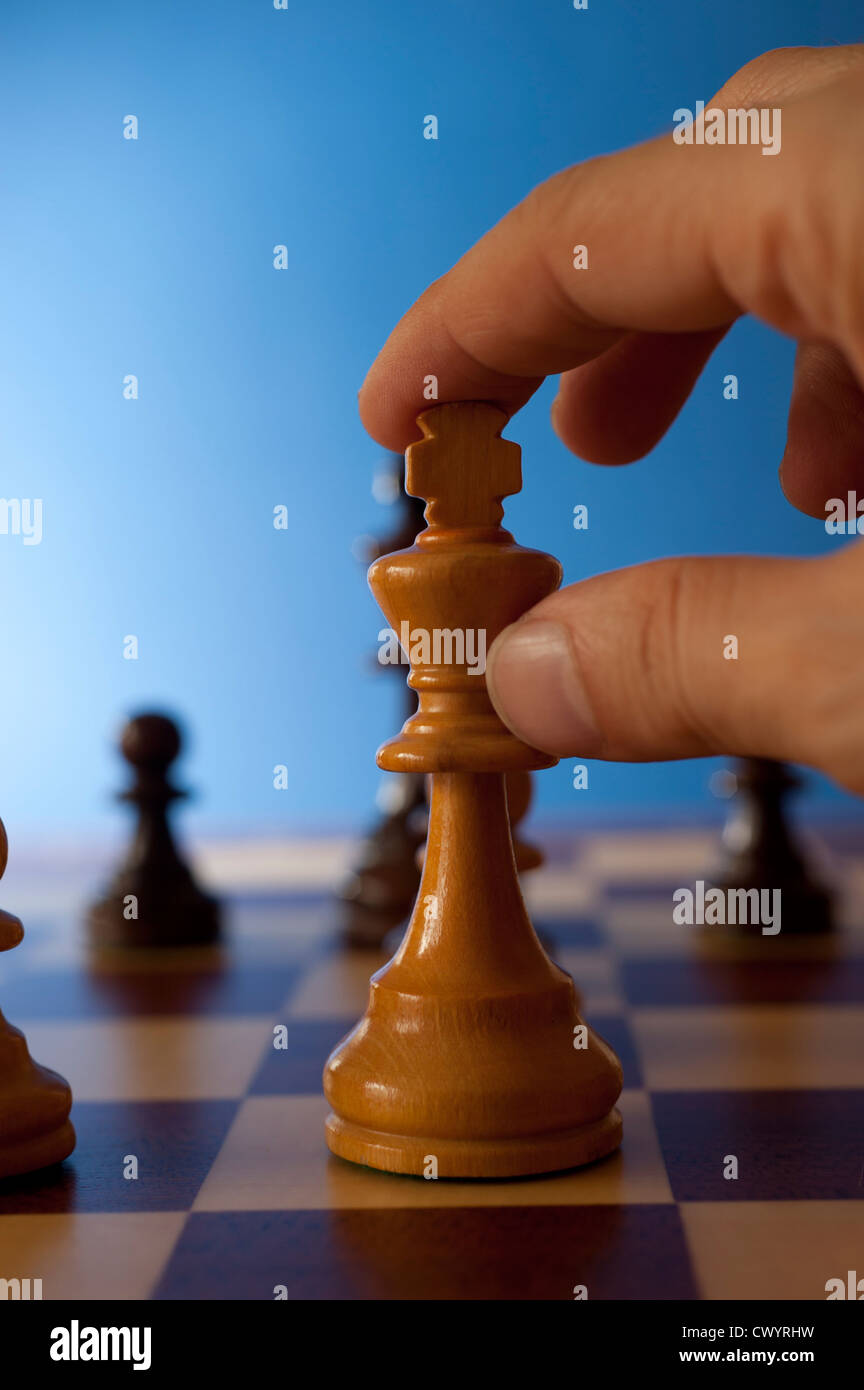 playing a chess king move Stock Photo - Alamy