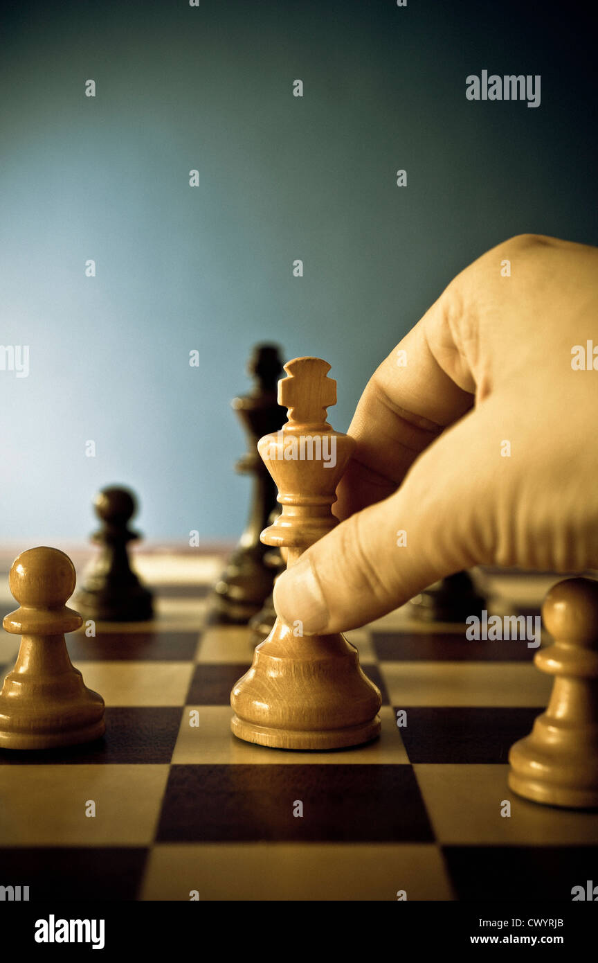 playing a chess king move Stock Photo - Alamy