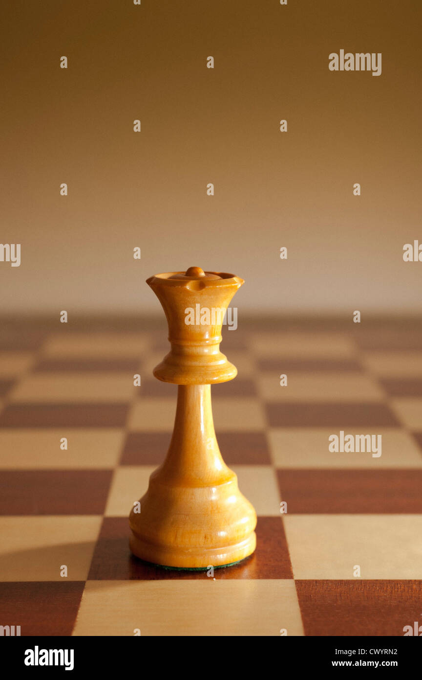 white chess queen on a chessboard Stock Photo - Alamy