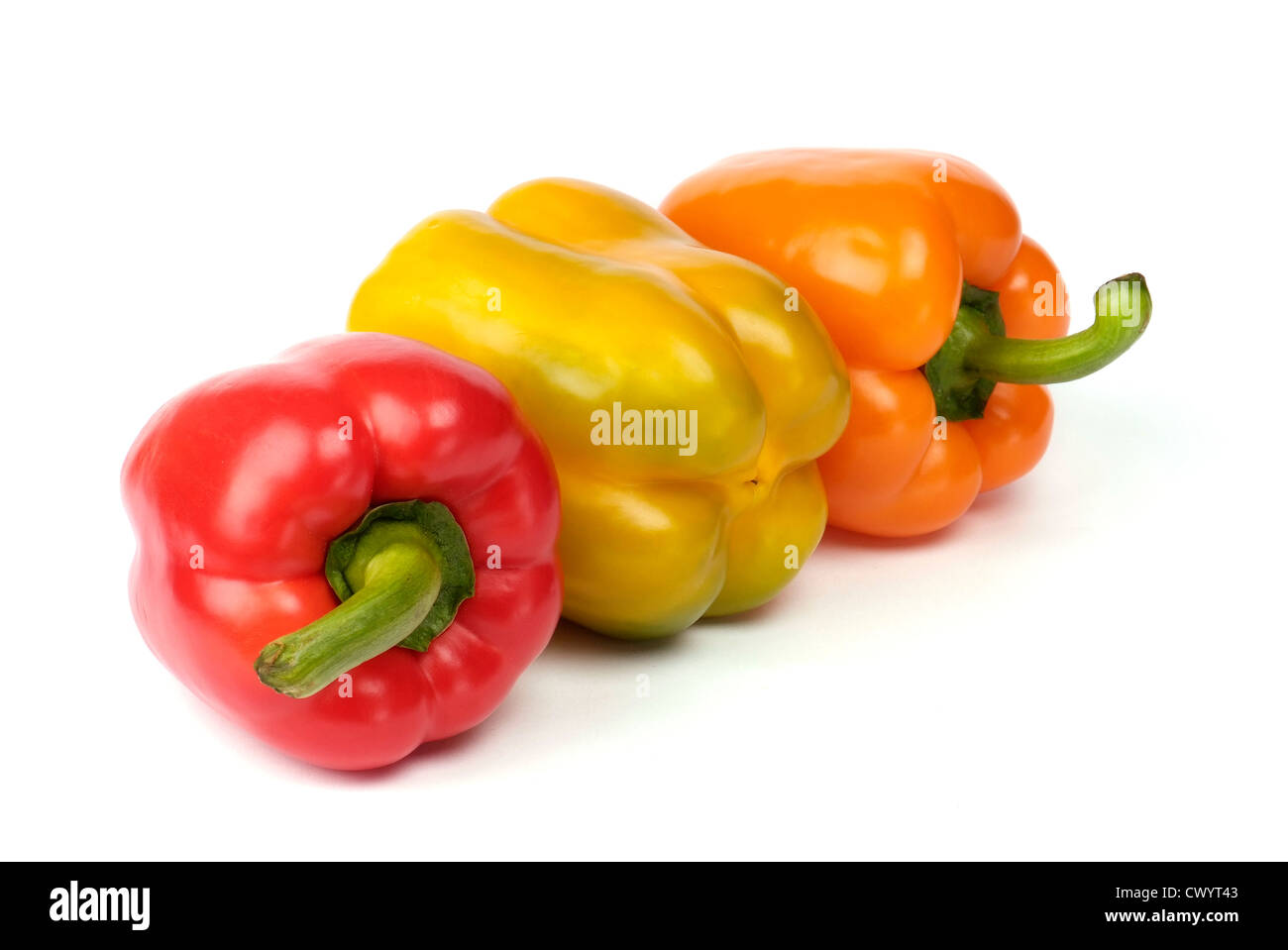 three colorful peppers in a row isolated on white Stock Photo - Alamy