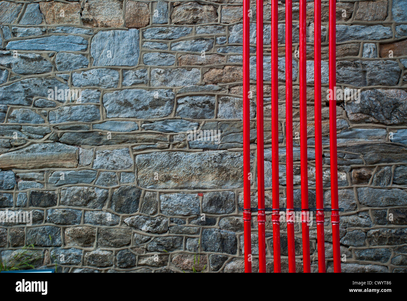 Stone Wall With Red Pipes Stock Photo - Alamy