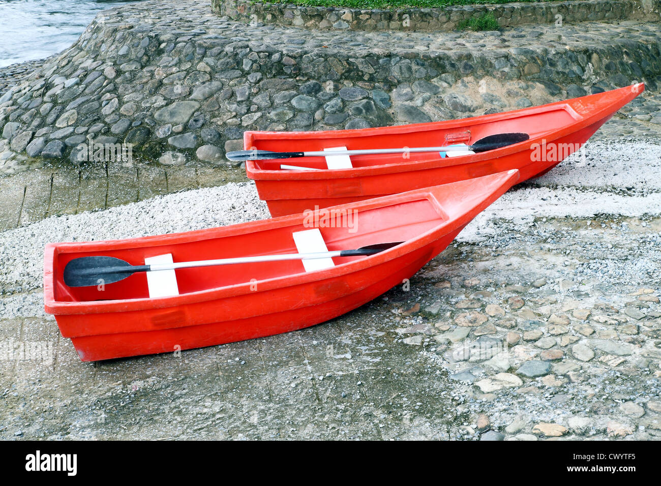 two red rowboat near the river Stock Photo - Alamy