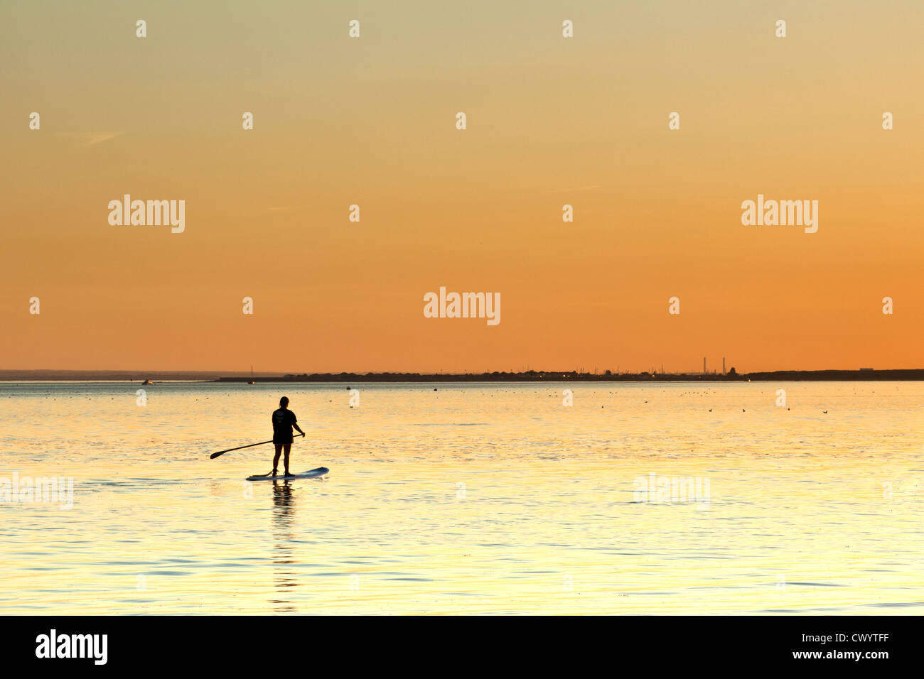 Person Stood on Surfboards Using Oar to Row Stock Photo - Alamy