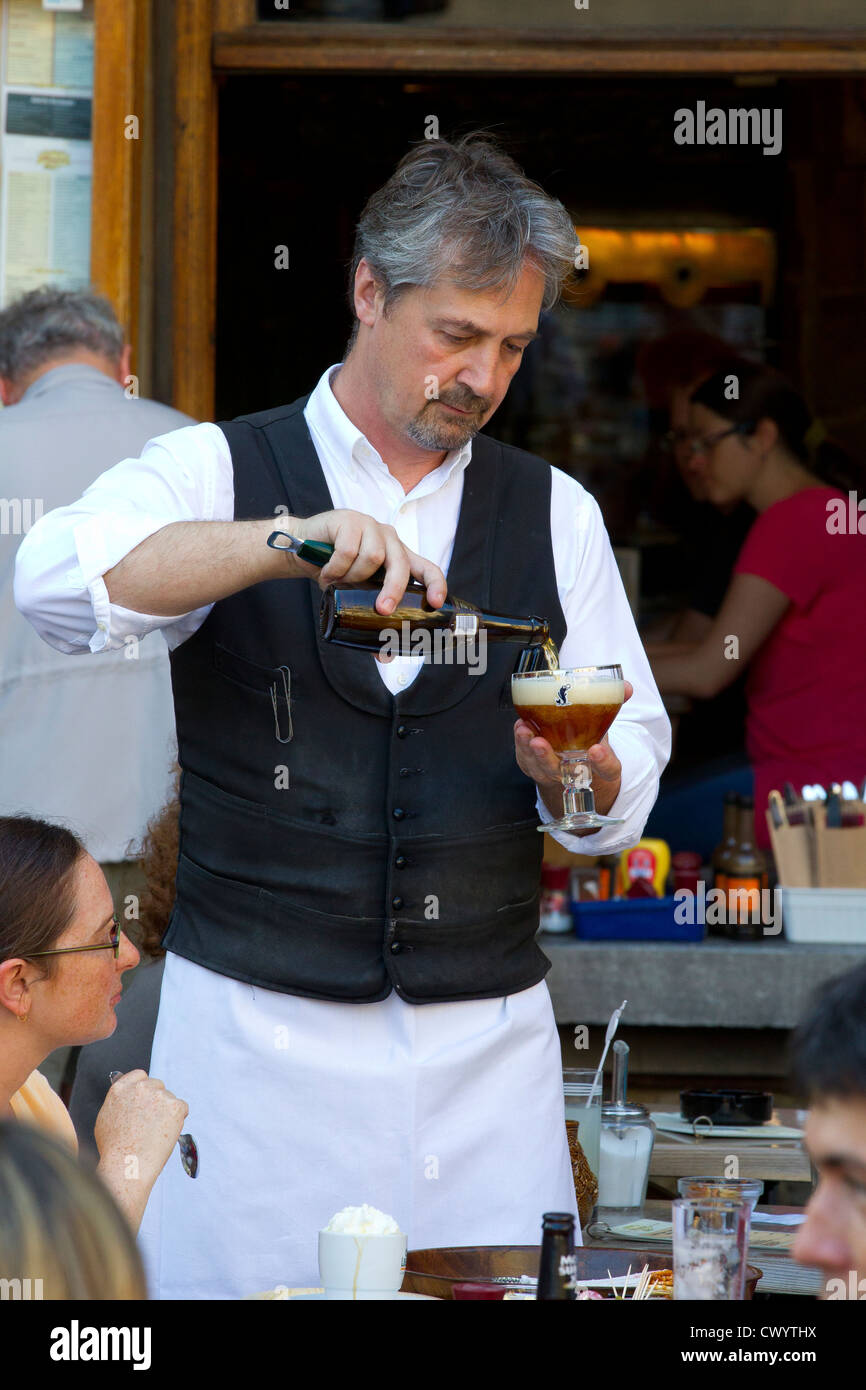 waiter serving pouring glass belgian beer belgium Stock Photo - Alamy
