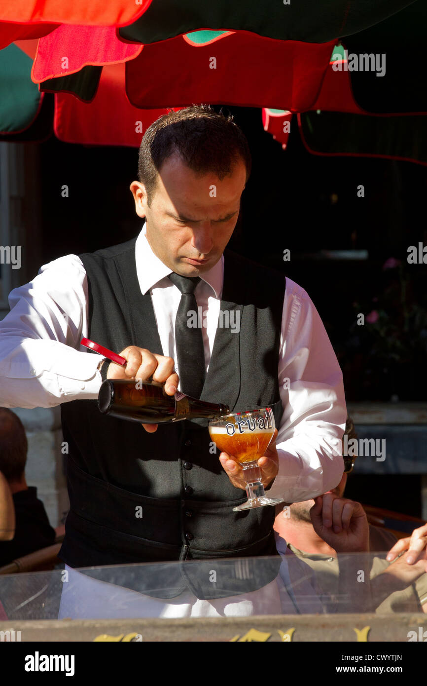 waiter serving pouring glass belgian beer belgium Stock Photo - Alamy