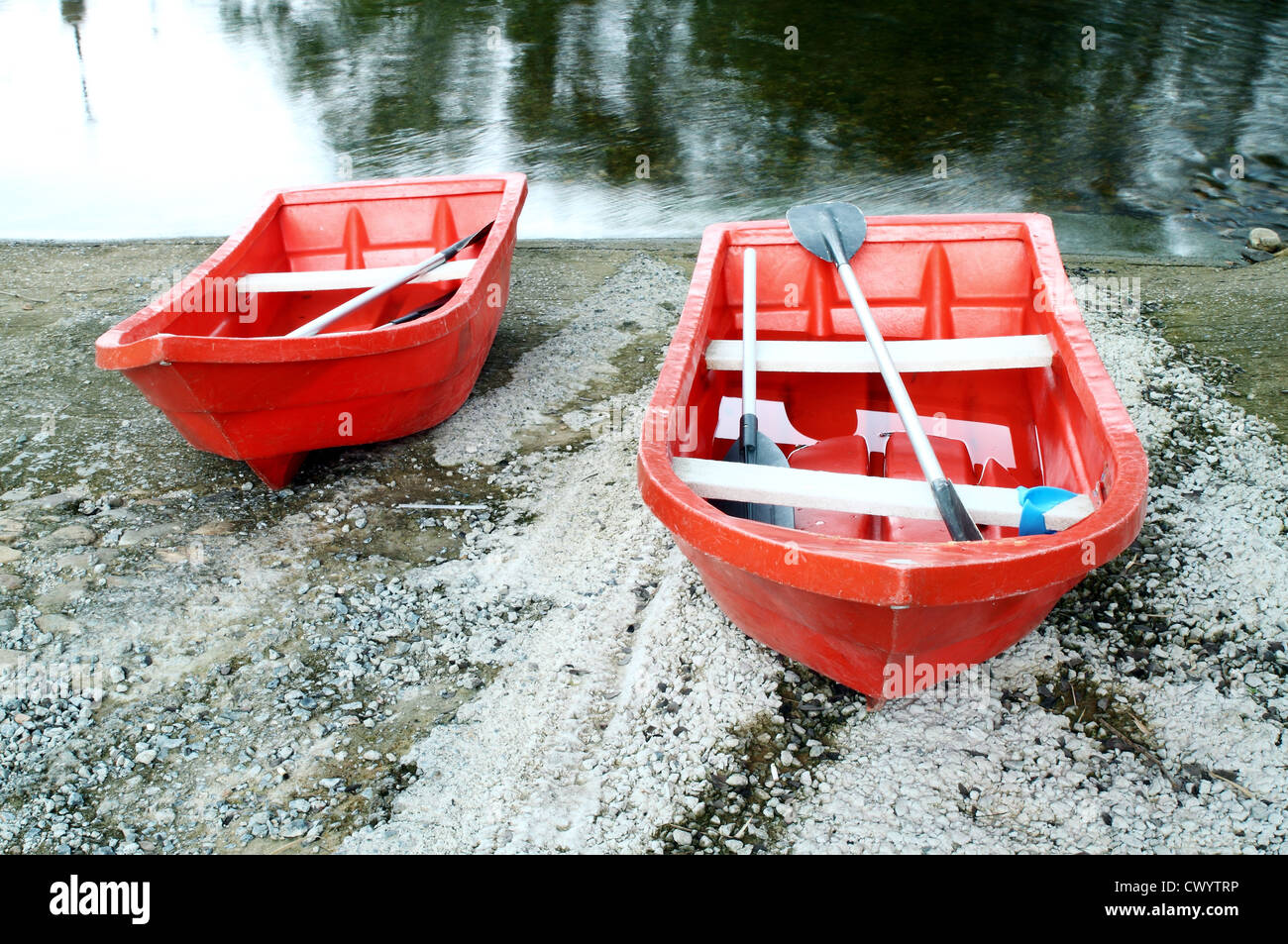 two red rowboat near the river Stock Photo - Alamy