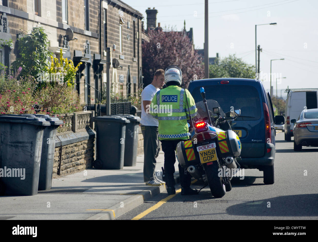 Police officer on a motorbike talking to a van driver after stopping ...