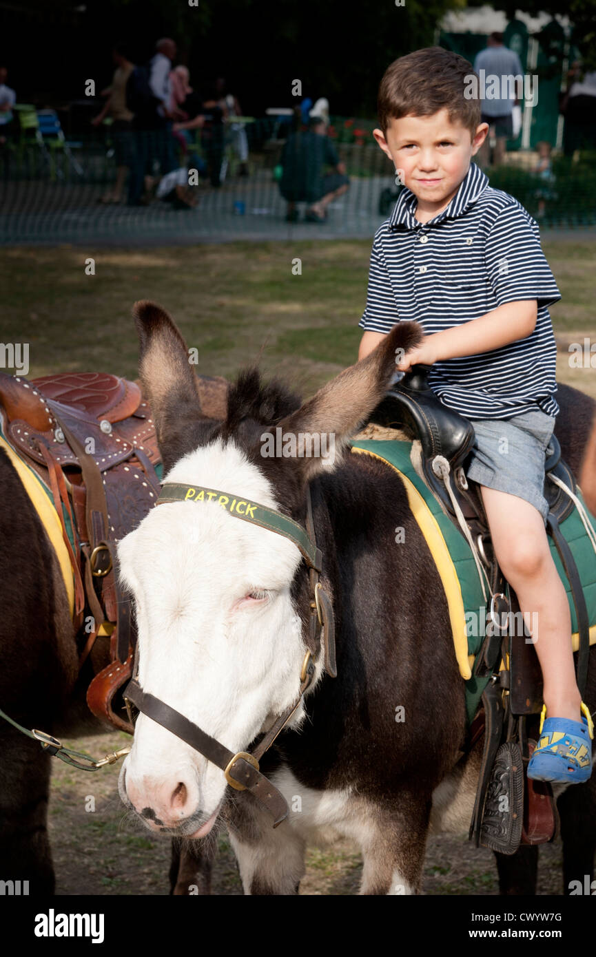 Young Boy riding a donkey Stock Photo - Alamy