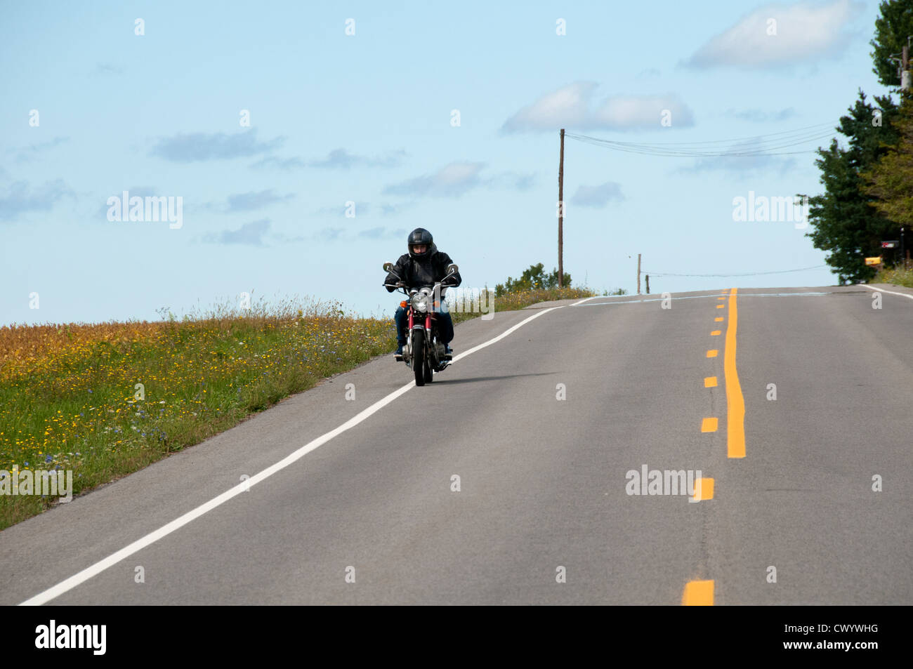 Biker on rural two lane highway Stock Photo - Alamy
