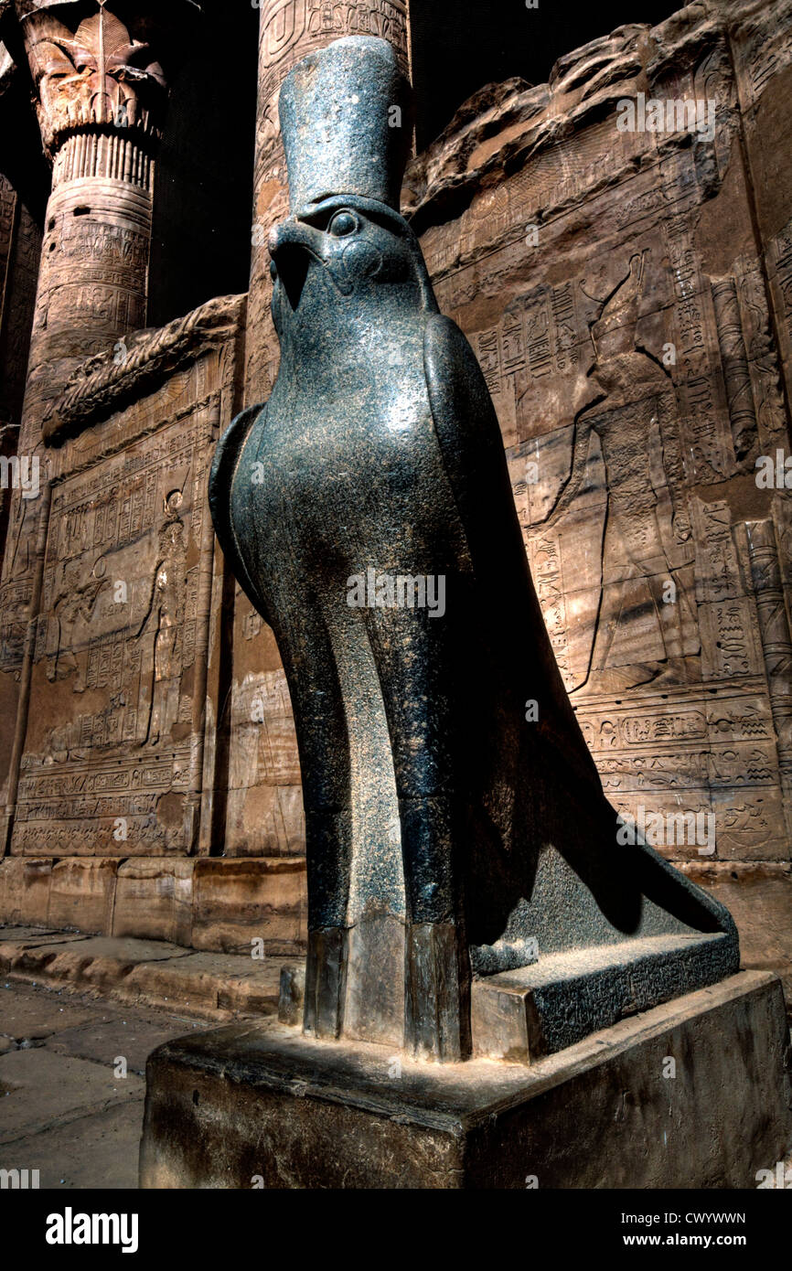 Statue of Horus in front of relief and hieroglyphs in the inner ...
