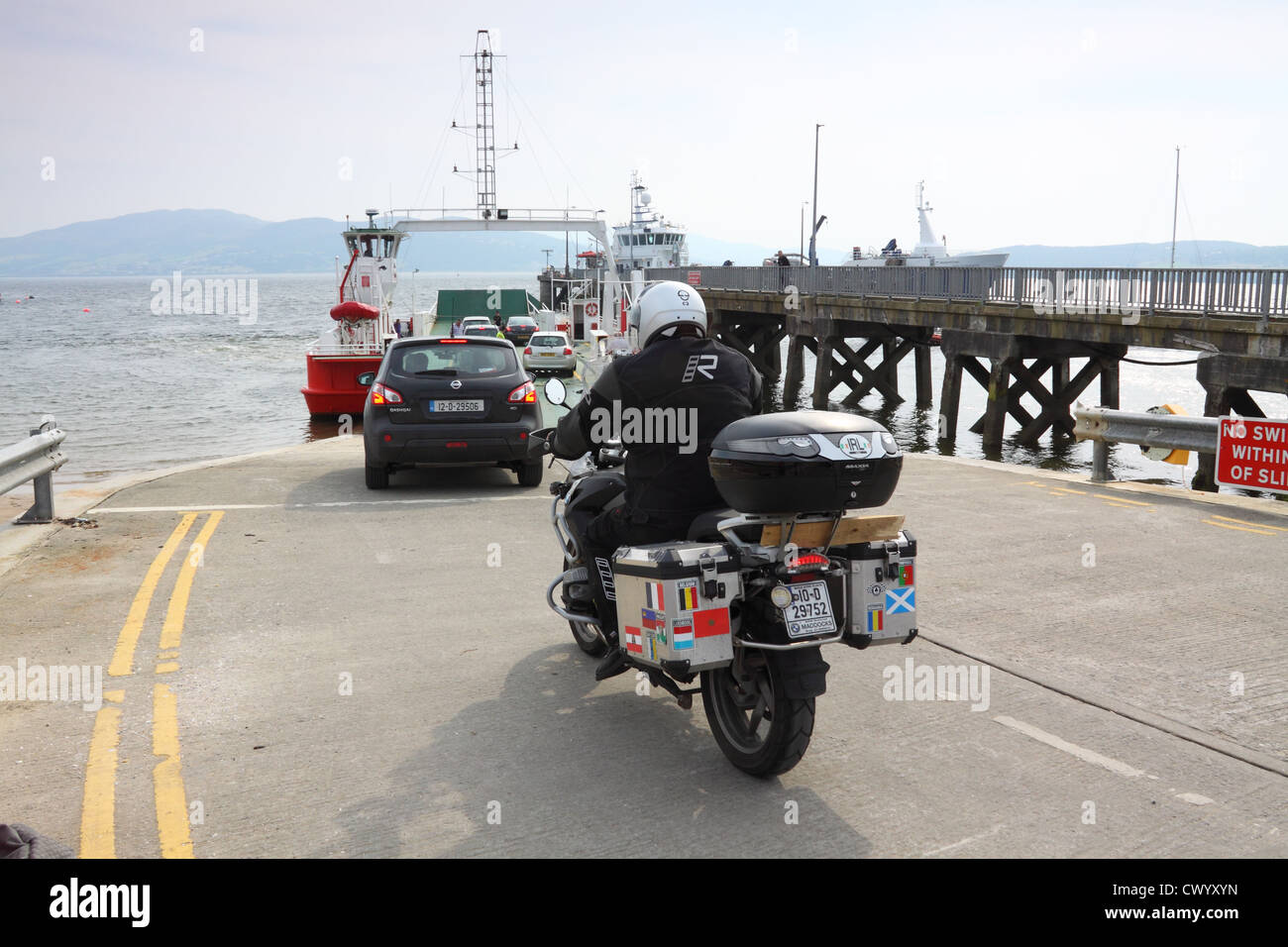 Motorcycle and cars boarding the ferry at Rathmullan, County Donegal ...