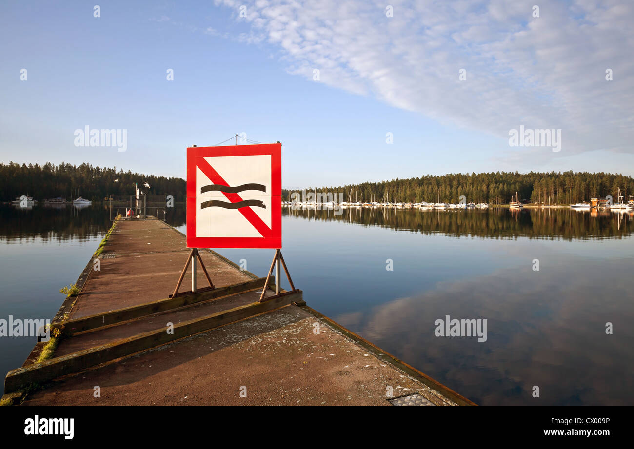 Water navigation mark "No wave" on the pier in small marina Stock Photo ...