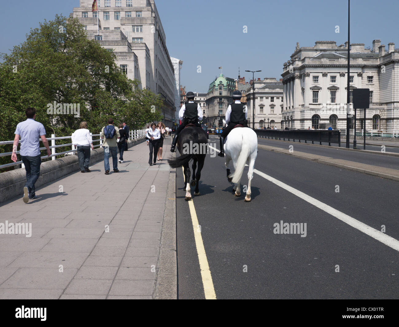 Two women police horse riders on patrol crossing Waterloo Bridge ...