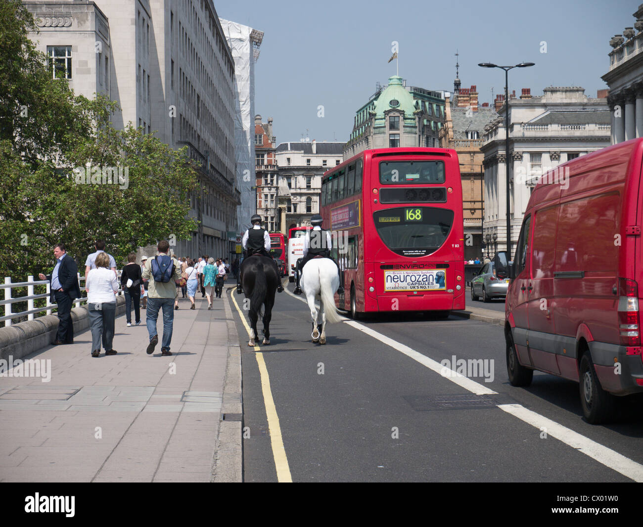 Two women police horse riders on patrol crossing Waterloo Bridge ...