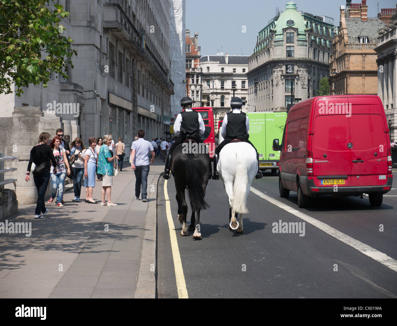 Two women police horse riders on patrol crossing Waterloo Bridge ...