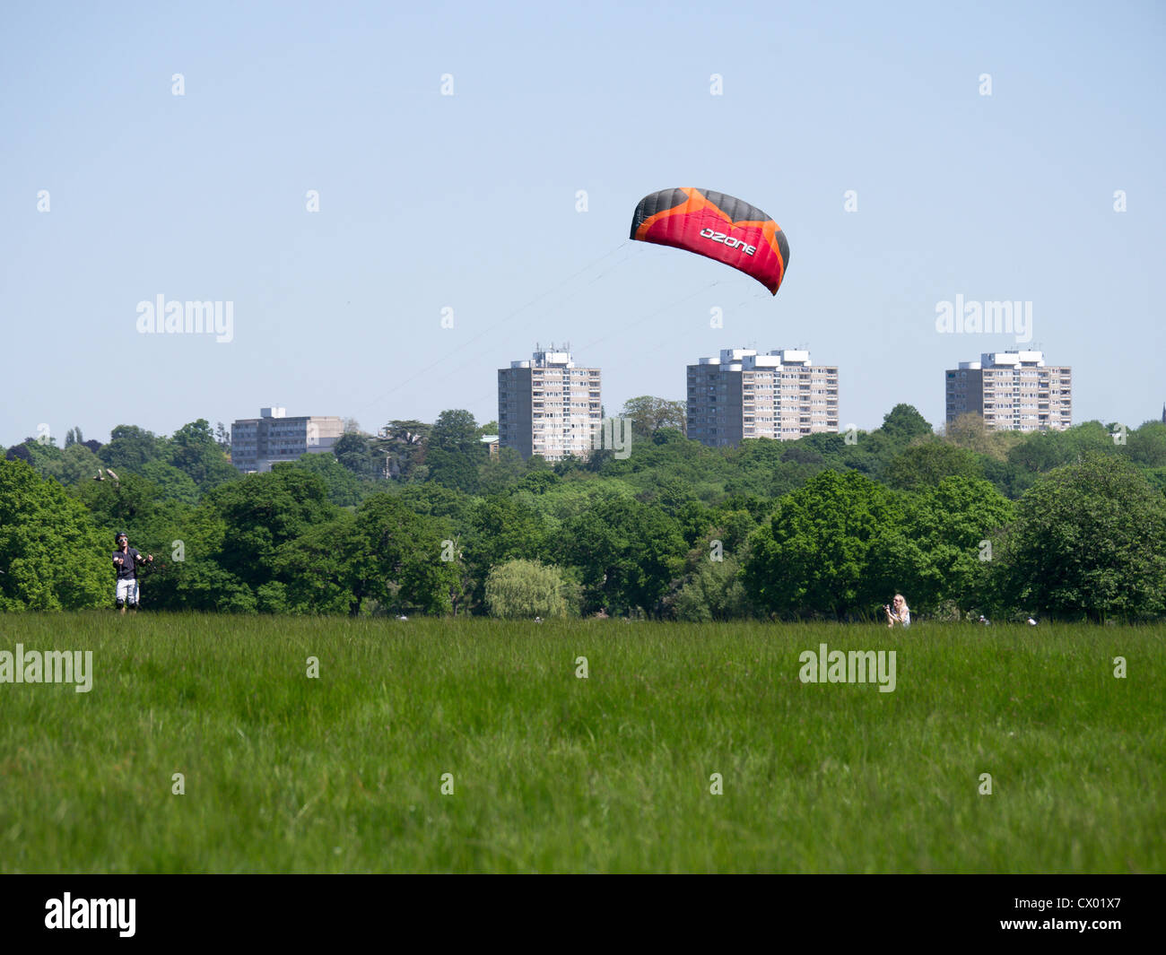 Flyng a kite in Richmond Park London England with the Roehampton flats ...