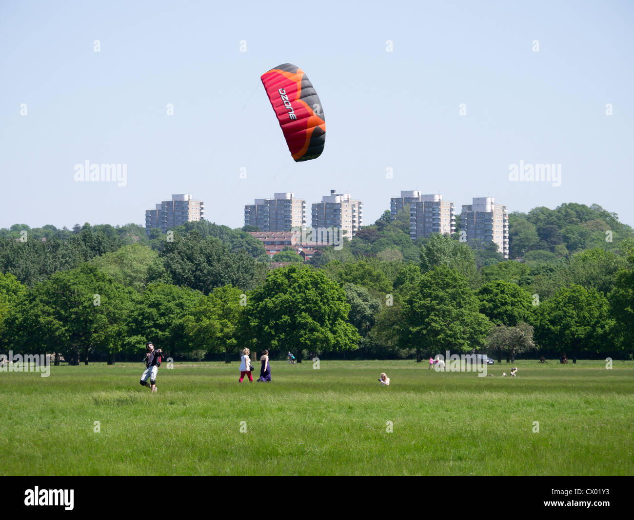 Flyng a kite in Richmond Park London England with the Roehampton flats ...