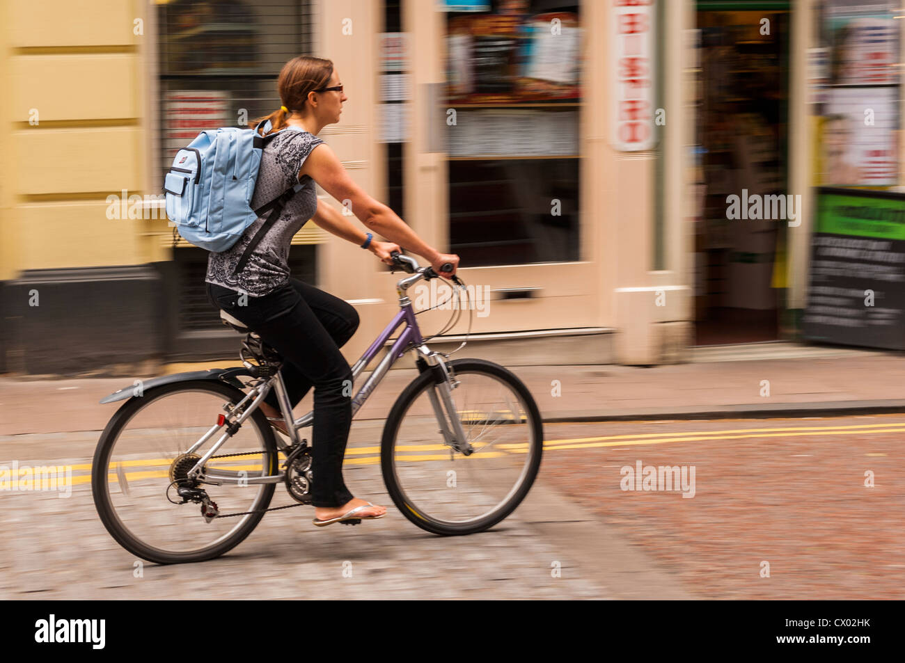 A female girl woman cycling showing movement in the Uk Stock Photo - Alamy