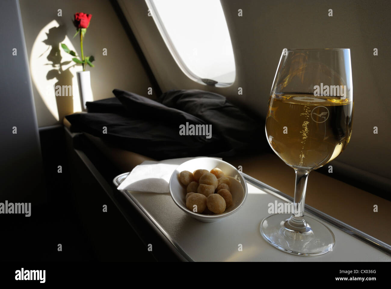 A glass of welcome vintage champagne and the signature red rose in ...