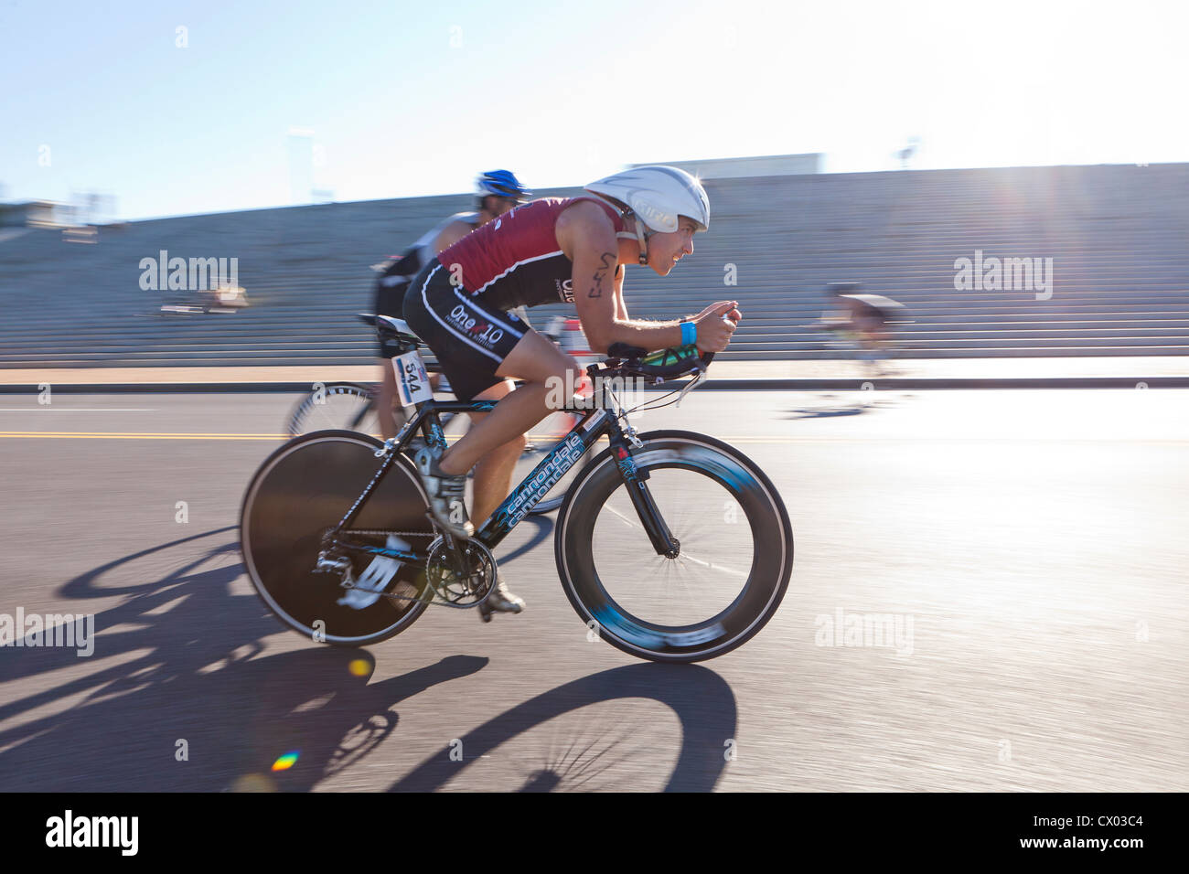 Cyclist racing in bright sun light - USA Stock Photo - Alamy