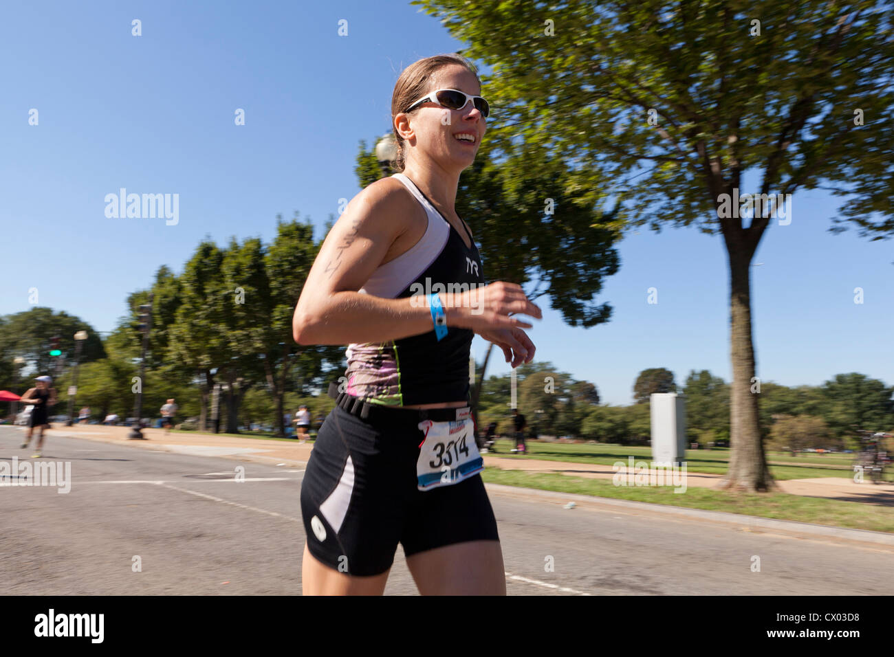 A woman running in a marathon Stock Photo - Alamy