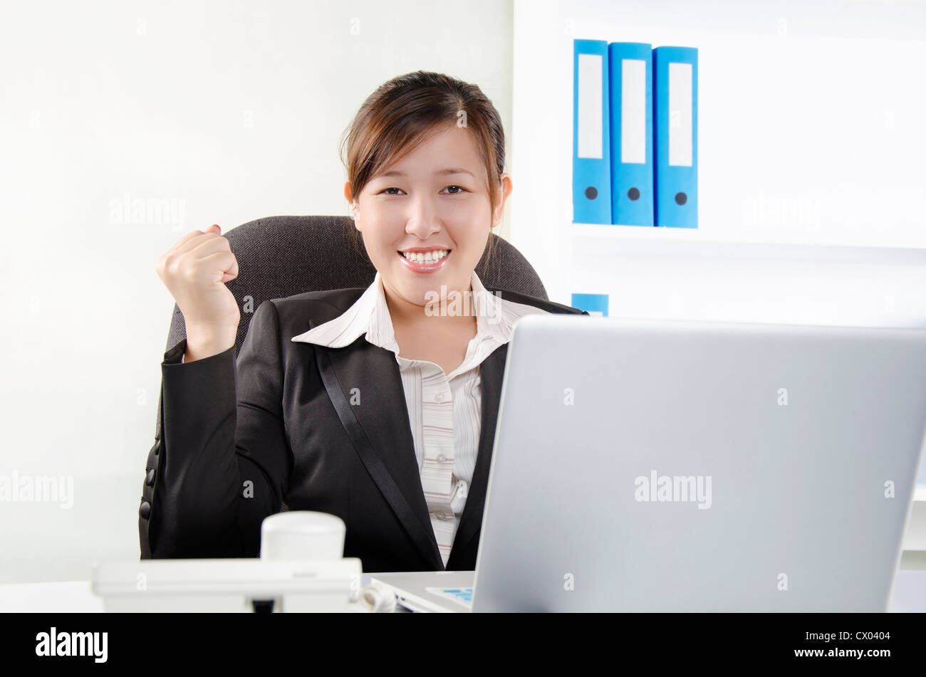 Female executive show success gesturing Stock Photo - Alamy