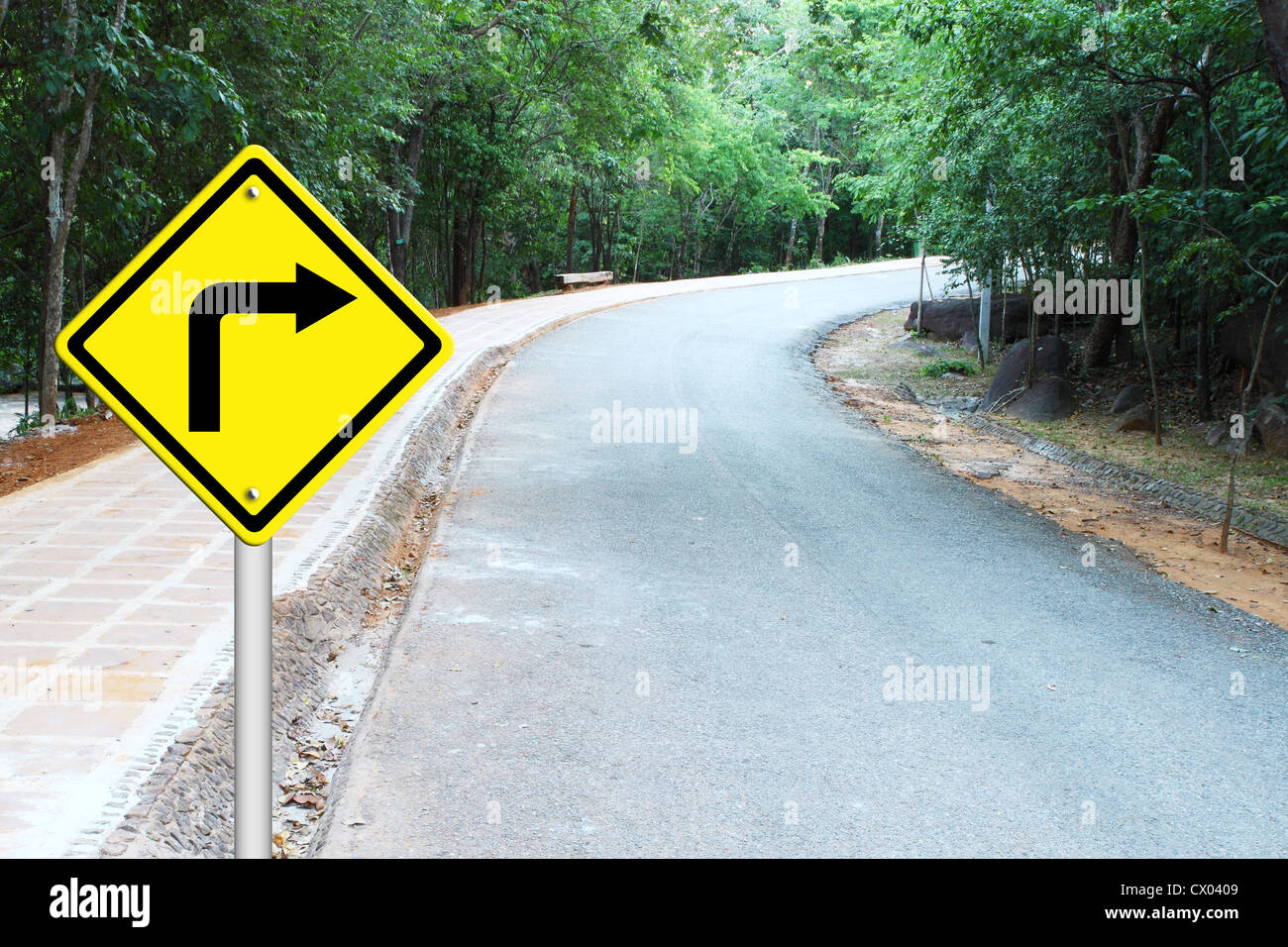 Turn right warning sign on a curve road Stock Photo - Alamy