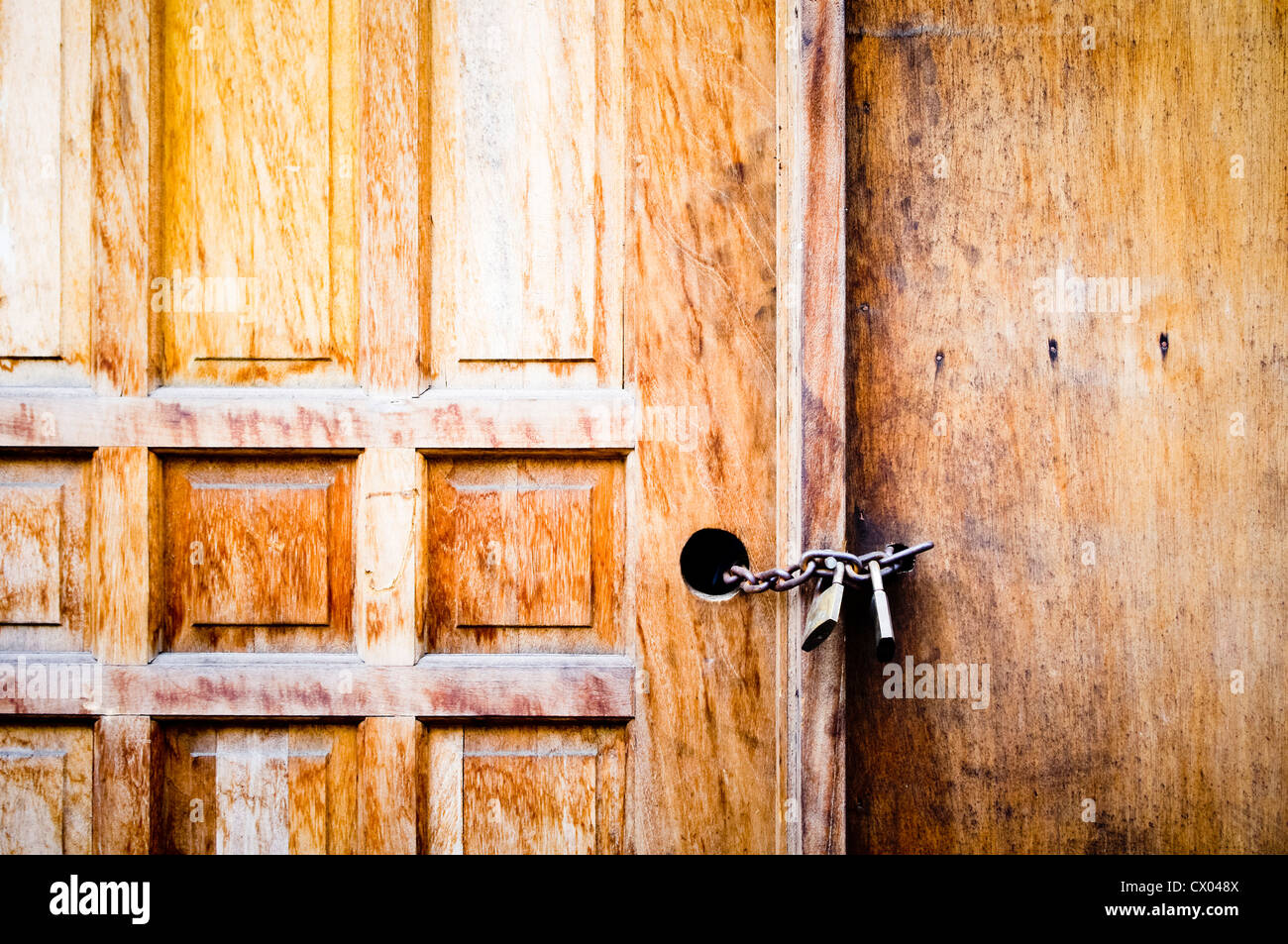 a wooden entrance is locked with a chain Stock Photo - Alamy
