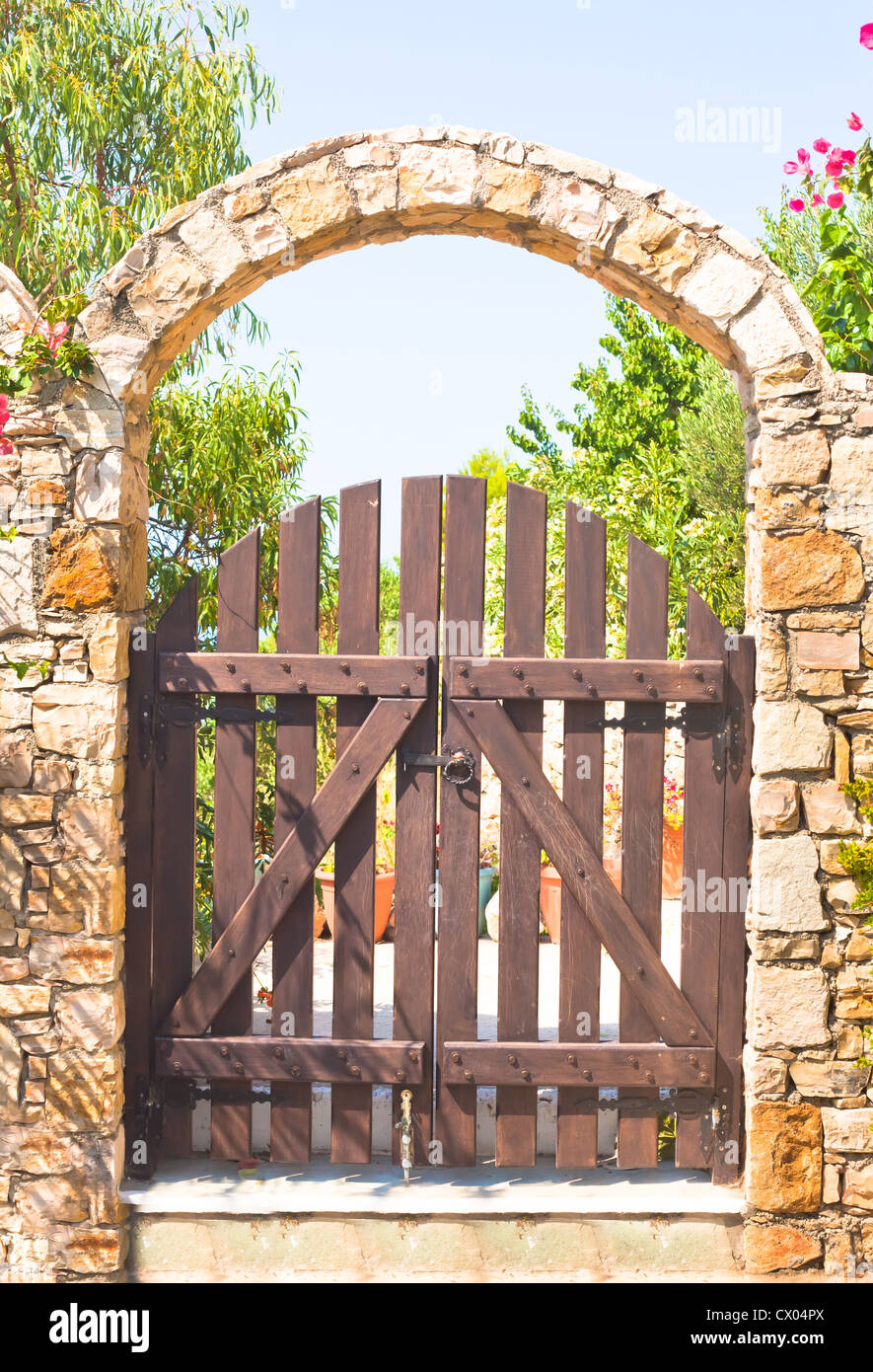 A nice stone arch gateway in a greek villa Stock Photo - Alamy