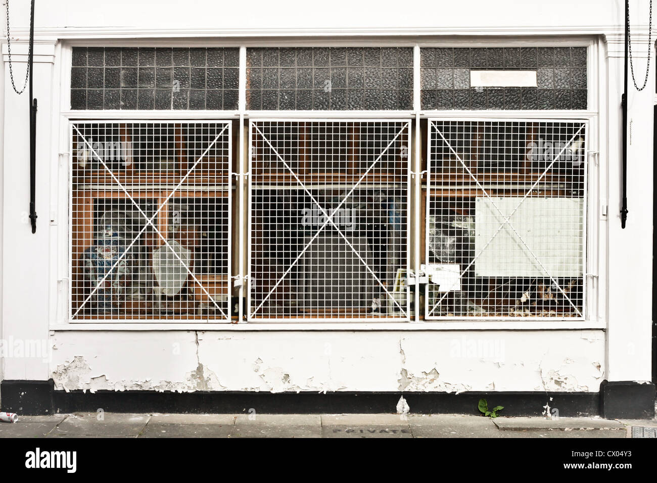 A store protected by window metal bars in a town Stock Photo - Alamy