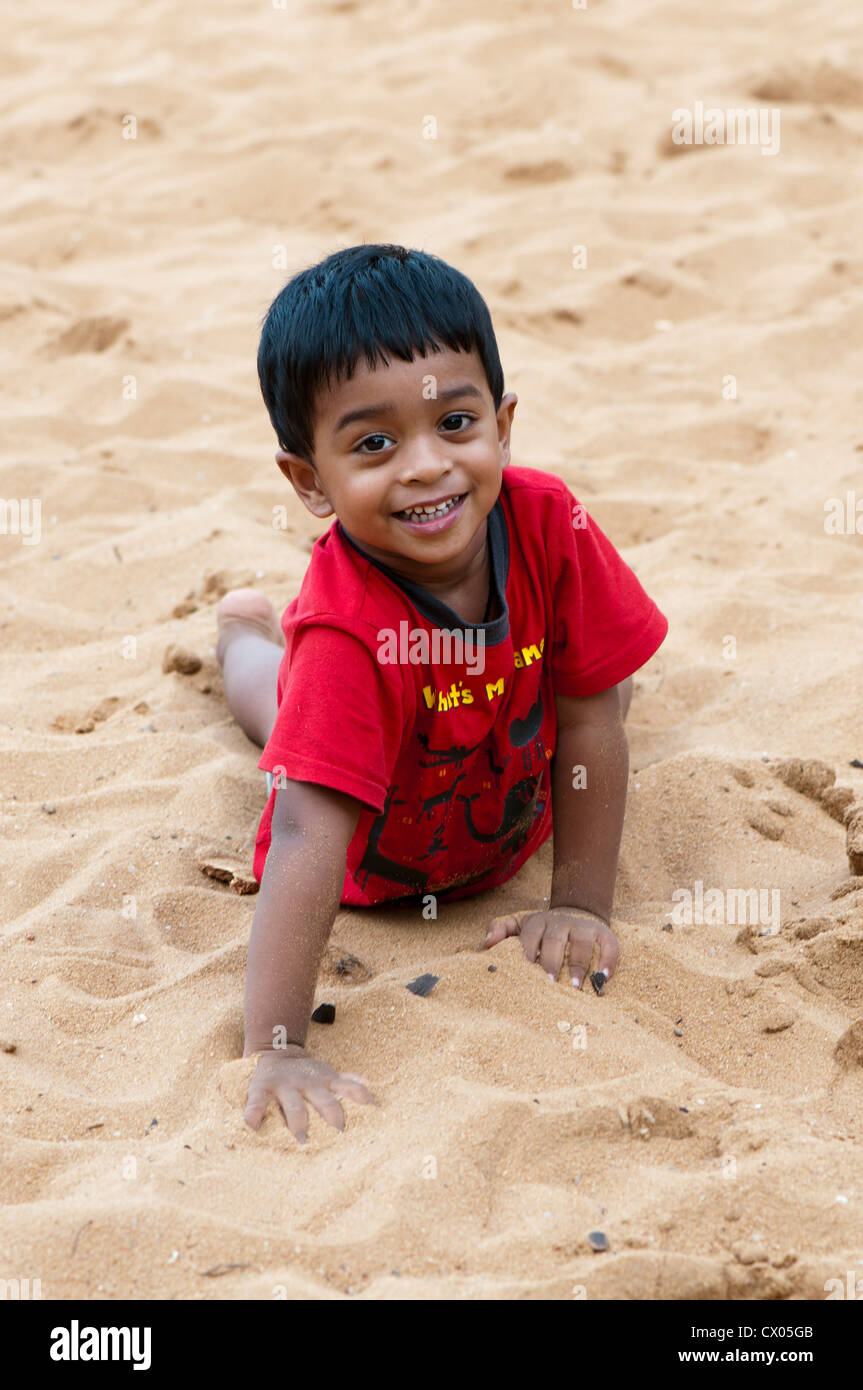 Indian boy child playing in sand Stock Photo - Alamy