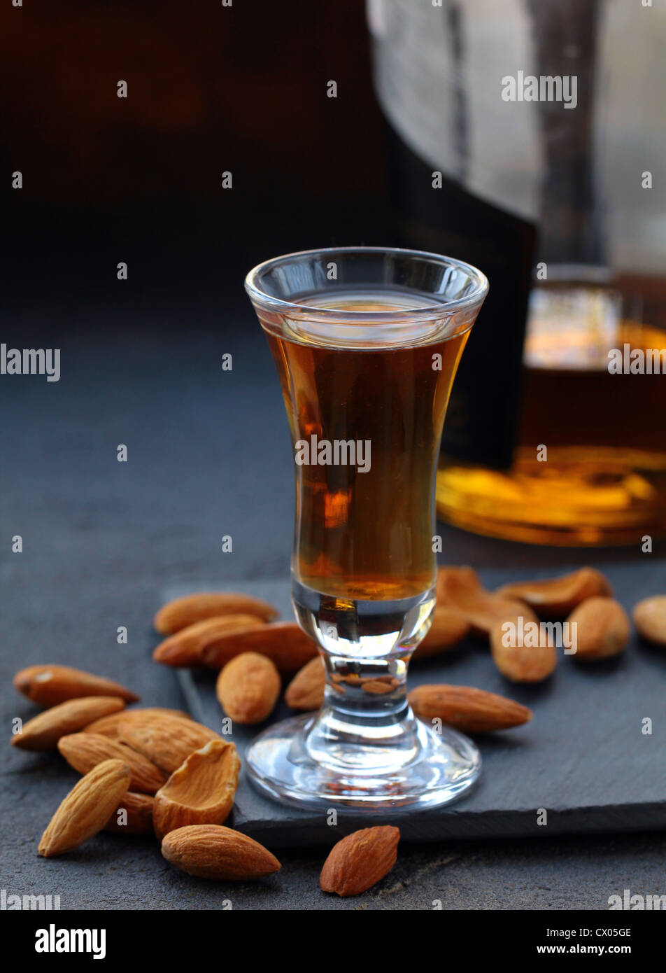 Almond liquor amaretto with whole nuts on a dark background Stock Photo ...