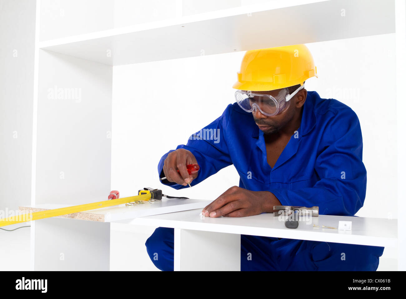 african american carpenter assembly furniture Stock Photo - Alamy