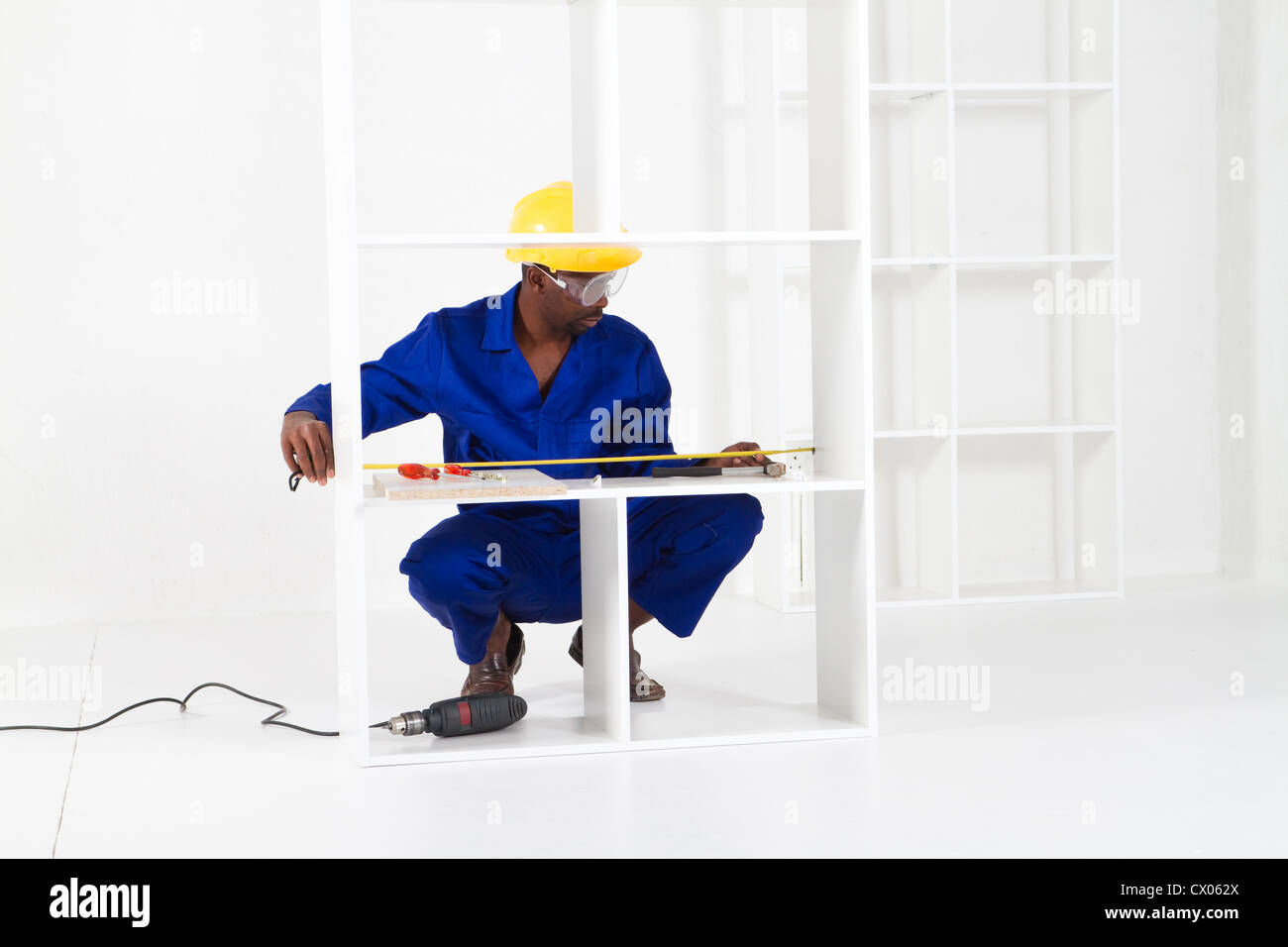 african american carpenter assembly furniture Stock Photo - Alamy