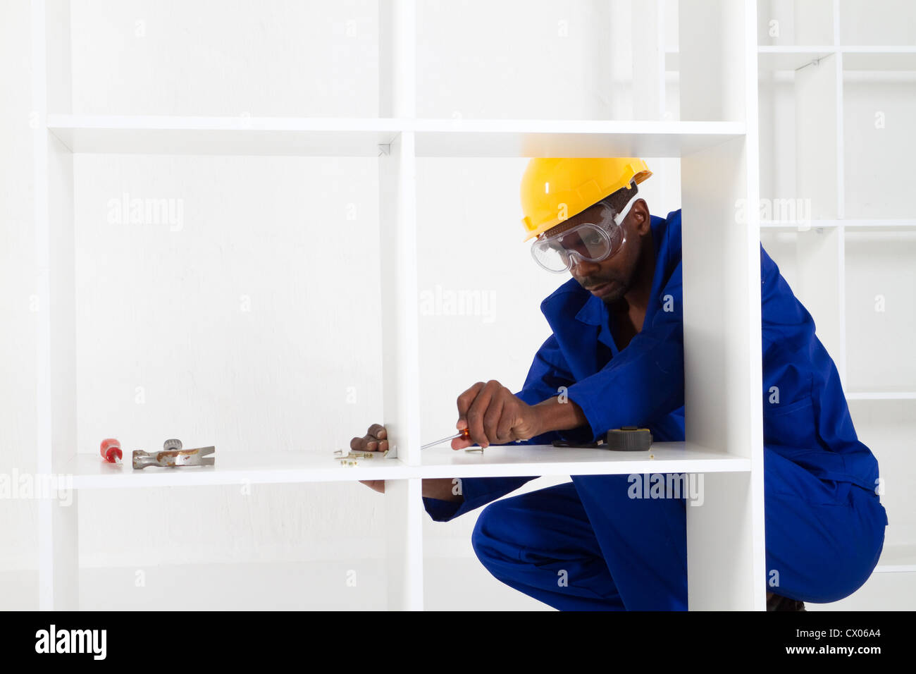 african american carpenter assembly furniture Stock Photo - Alamy