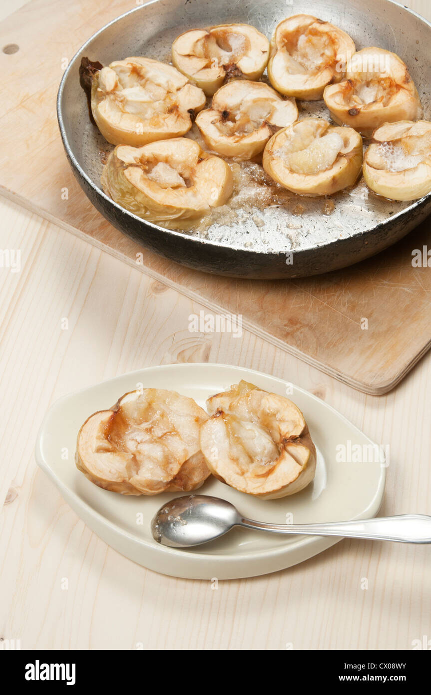 Baked apples in a frying pan and on a plate Stock Photo - Alamy