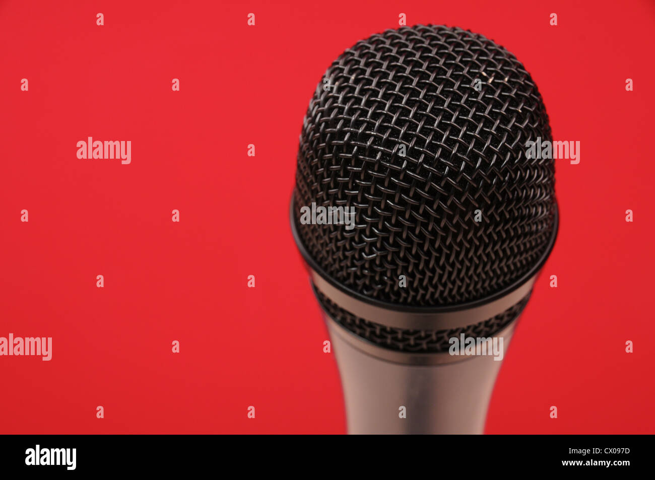 Microphone on red background Stock Photo - Alamy