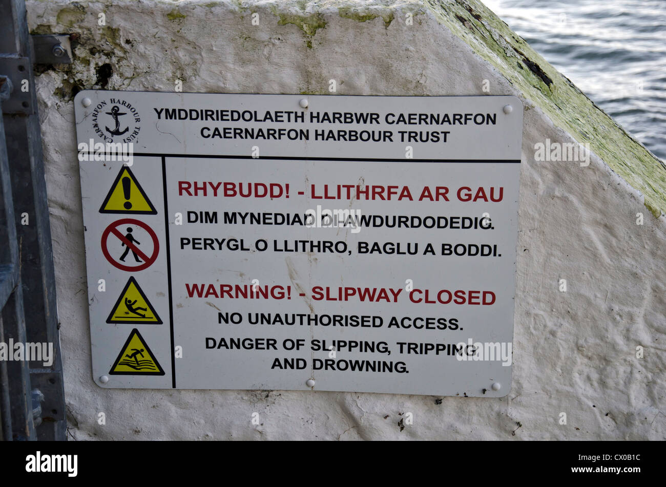 Harbour warning sign at Caernarfon in North Wales Stock Photo - Alamy