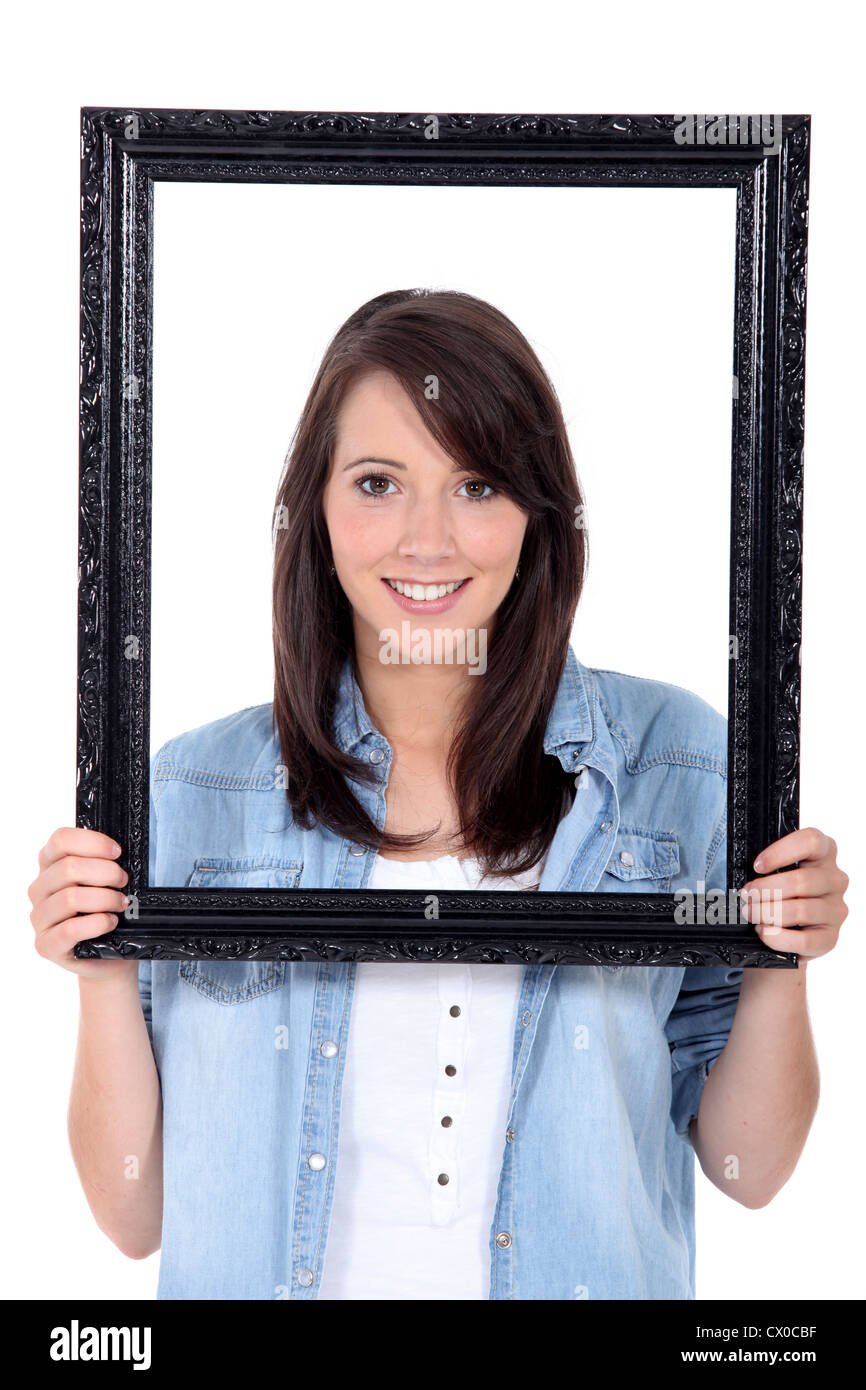 Woman holding up a picture frame Stock Photo - Alamy