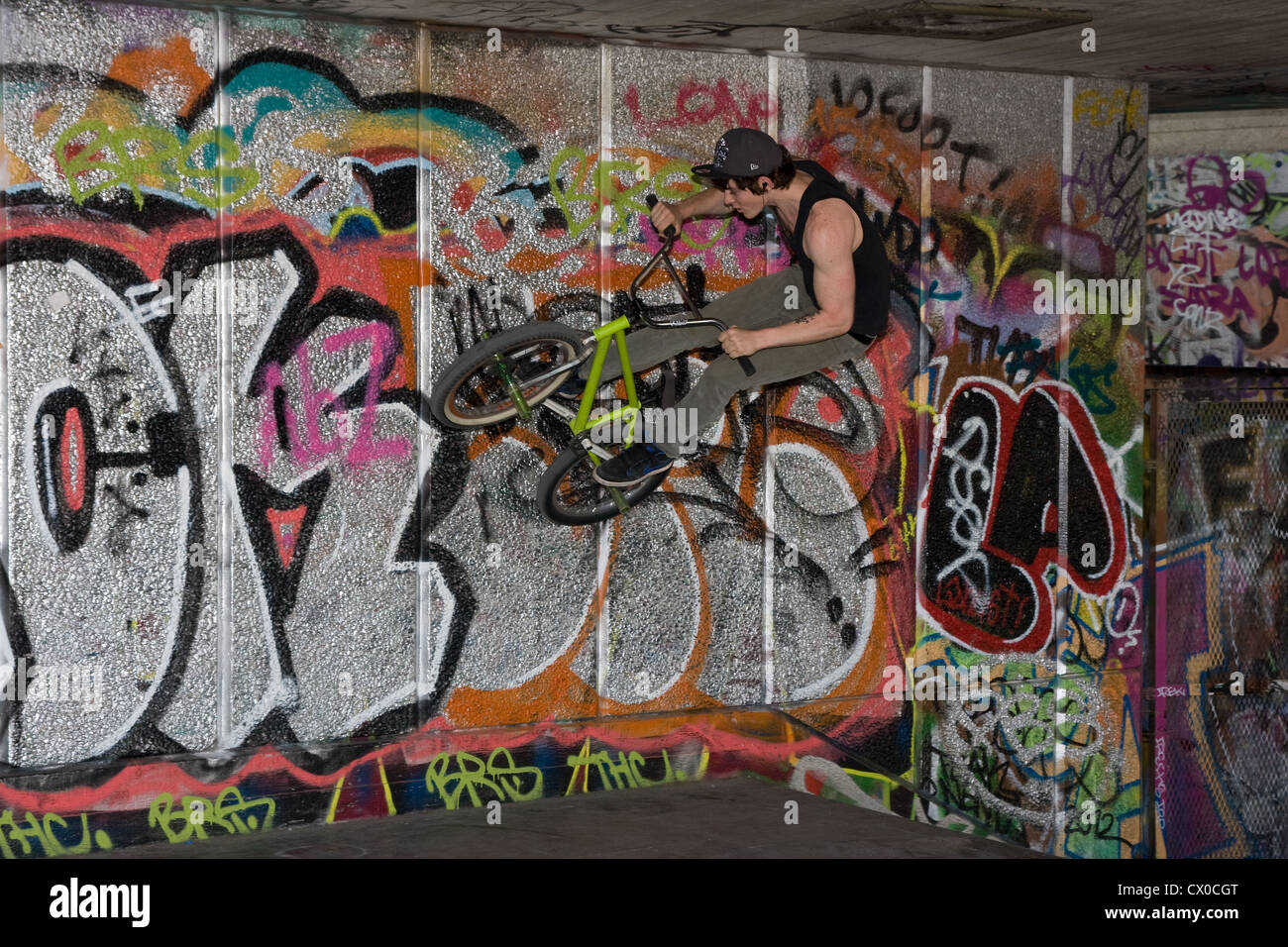 BMX freestyle bike riding 180 graffiti wall rider Stock Photo - Alamy