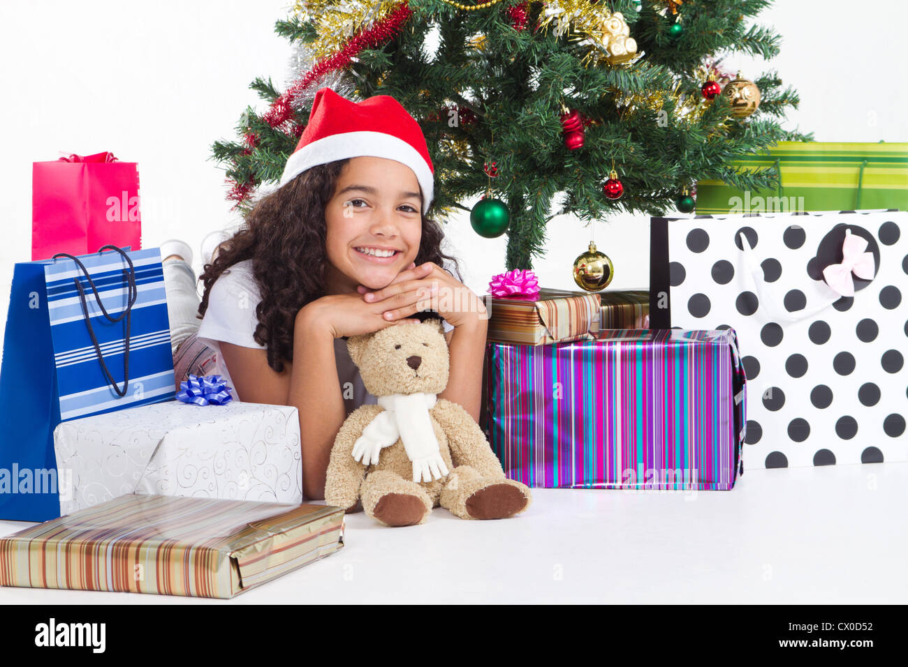 happy cute little girl with presents near a christmas tree Stock Photo ...