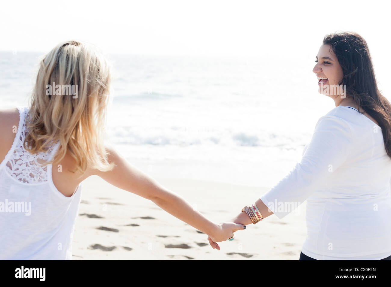 Two Women Holding Hands Behind Back High Resolution Stock Photography ...