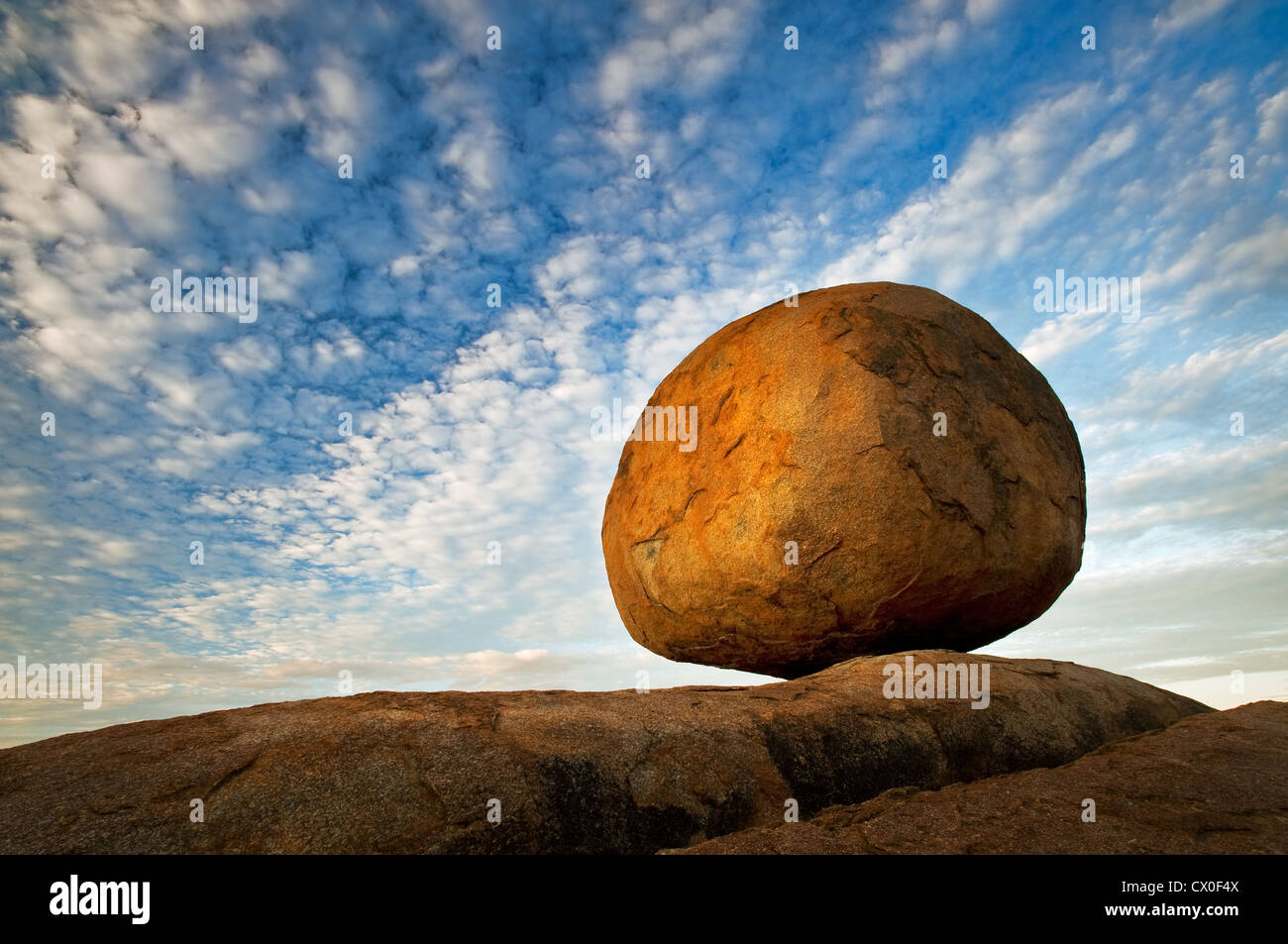 A granite boulder of the Devils Marbles glowing in the evening light ...