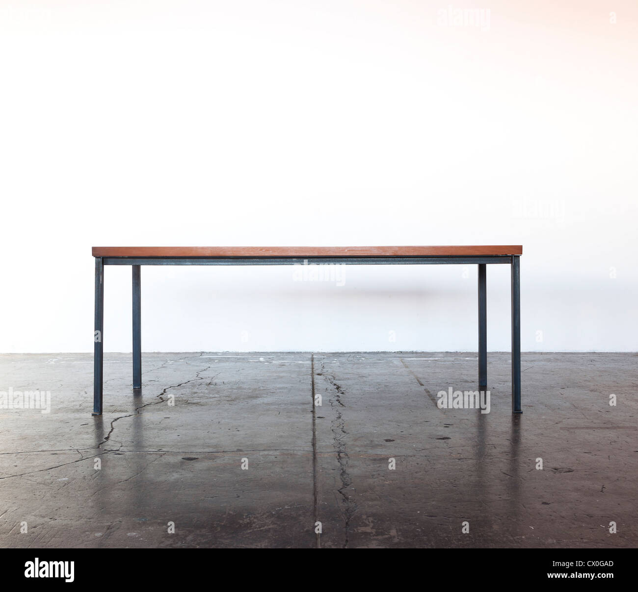 Iron Frame Wooden Table on Concrete Floor Stock Photo - Alamy