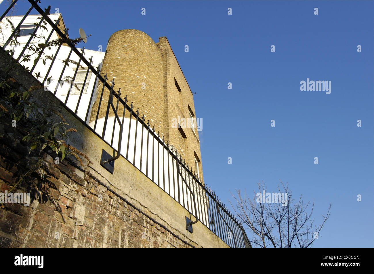 High wall and brick building towering to the sky Stock Photo - Alamy