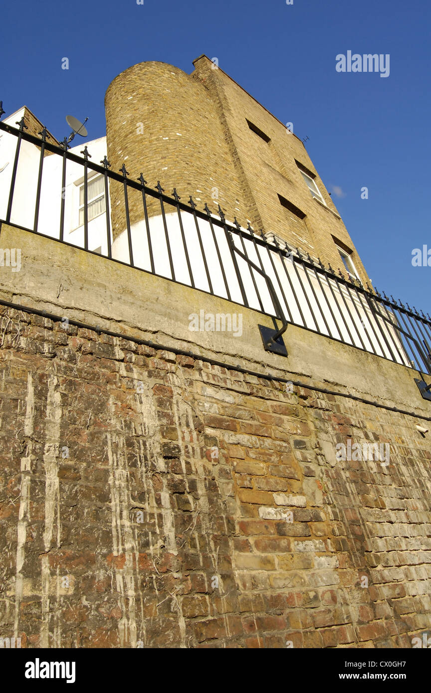 High wall and brick building towering to the sky Stock Photo - Alamy