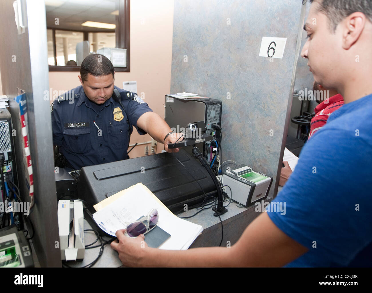 US Customs and Border Protection officer uses scanner to document and ...