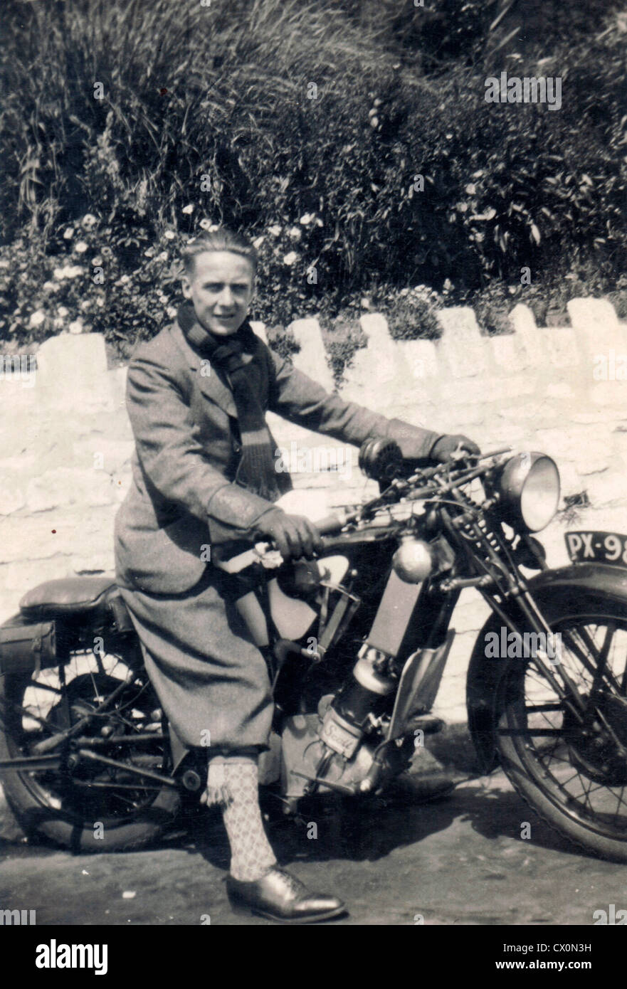A man smartly dressed in plus fours sitting on a water-cooled two ...