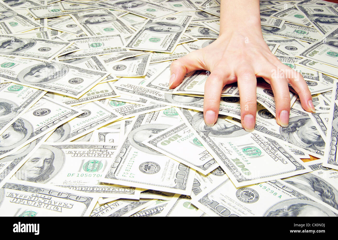 Hand with money isolated on money background Stock Photo - Alamy